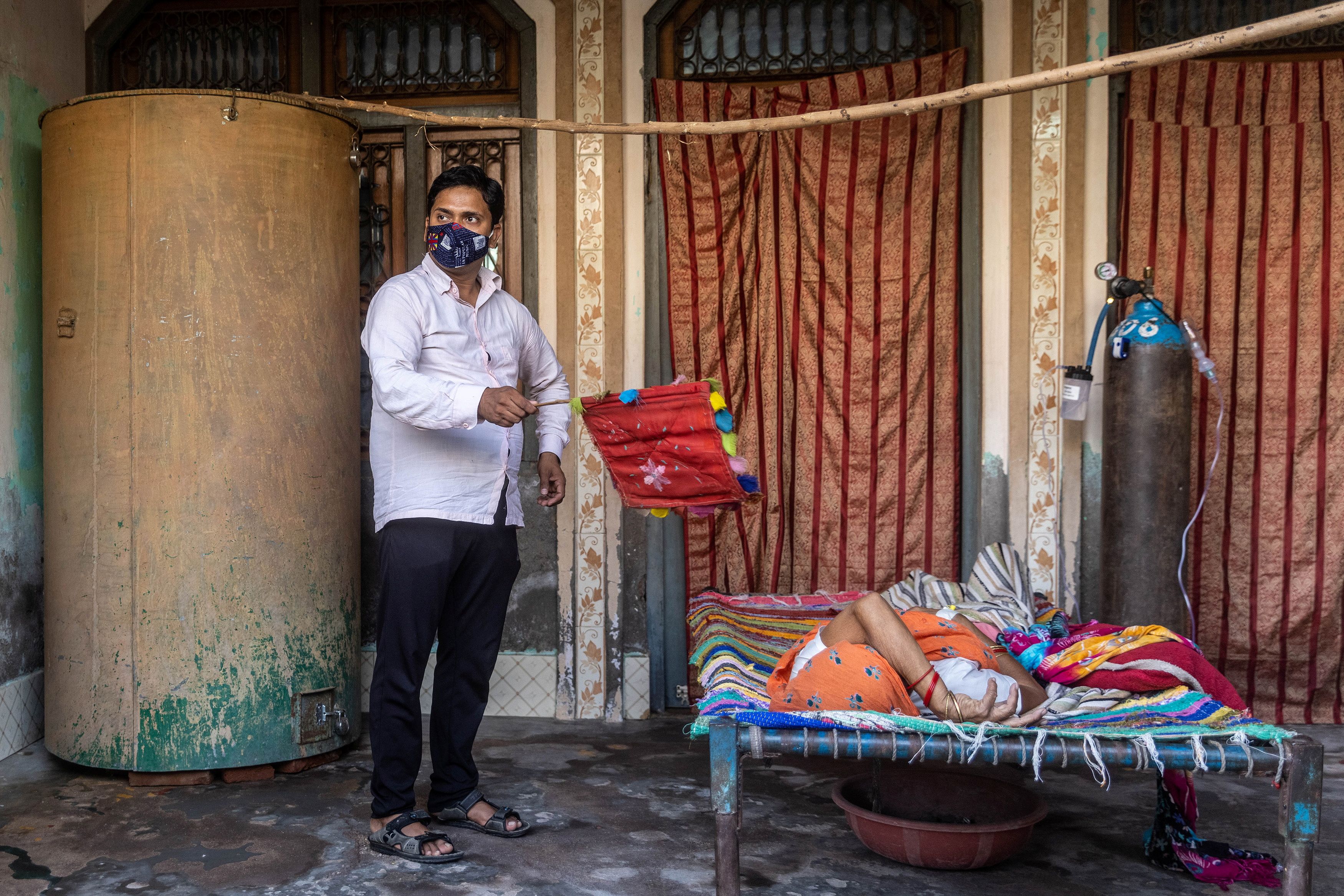Under a tree, one Indian village cares for its COVID-19 sick | Reuters