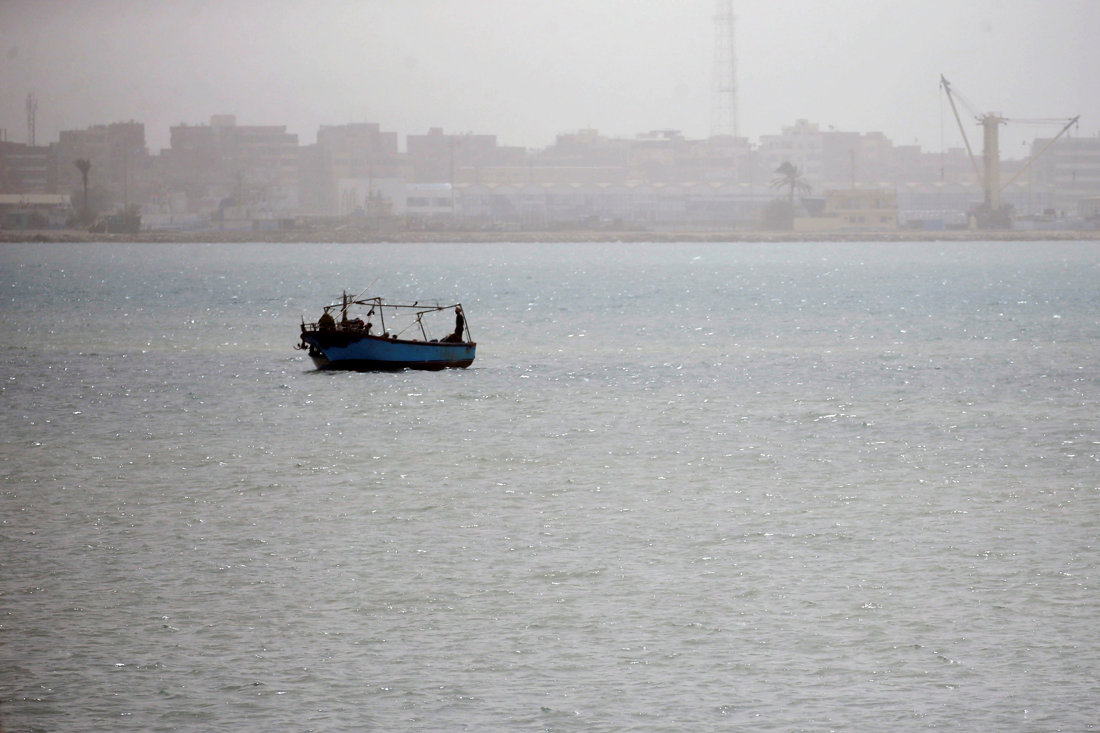 Tugs work to free giant container ship stranded in Suez Canal | Reuters
