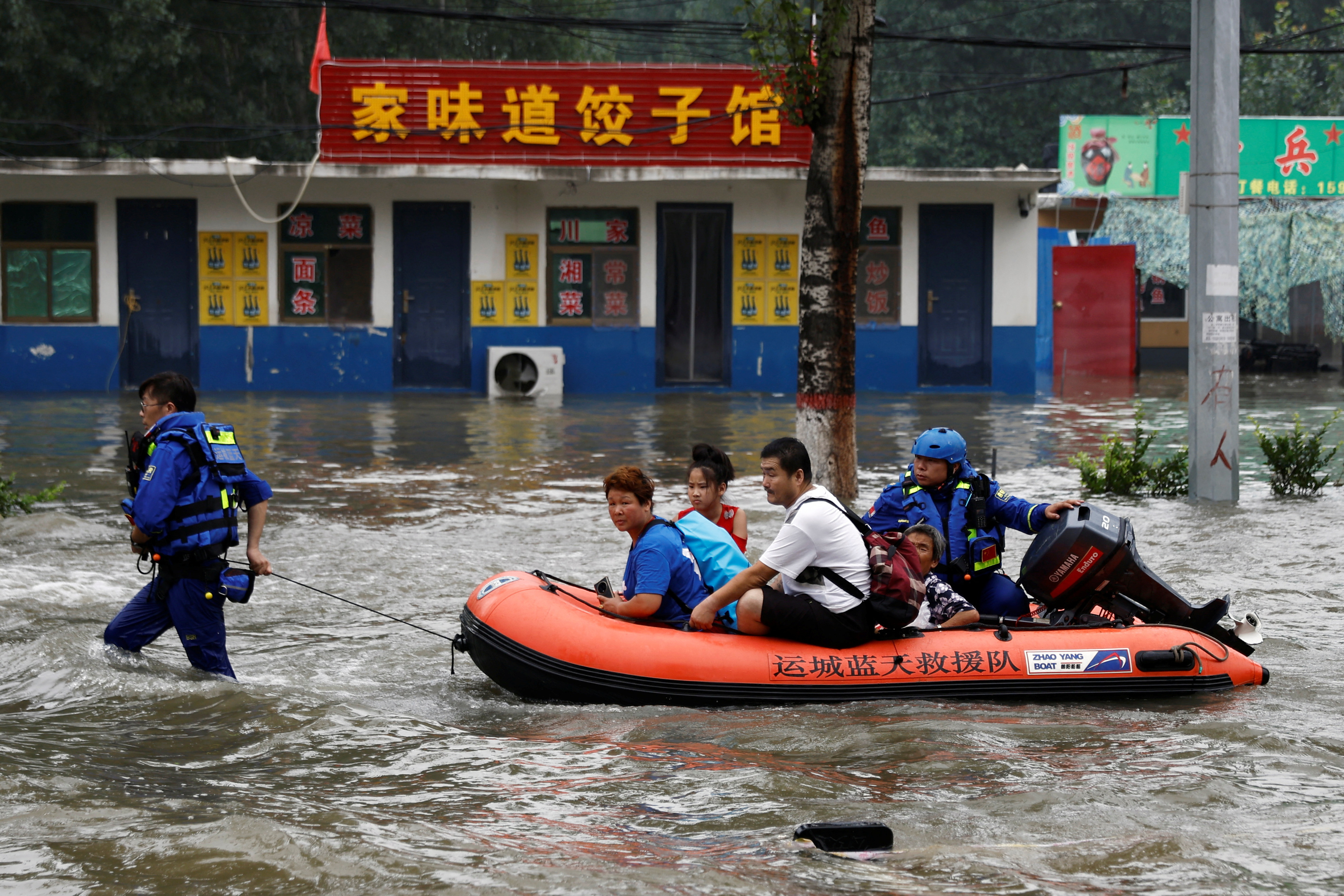 Flooded rivers, trapped residents test China's disaster response | Reuters