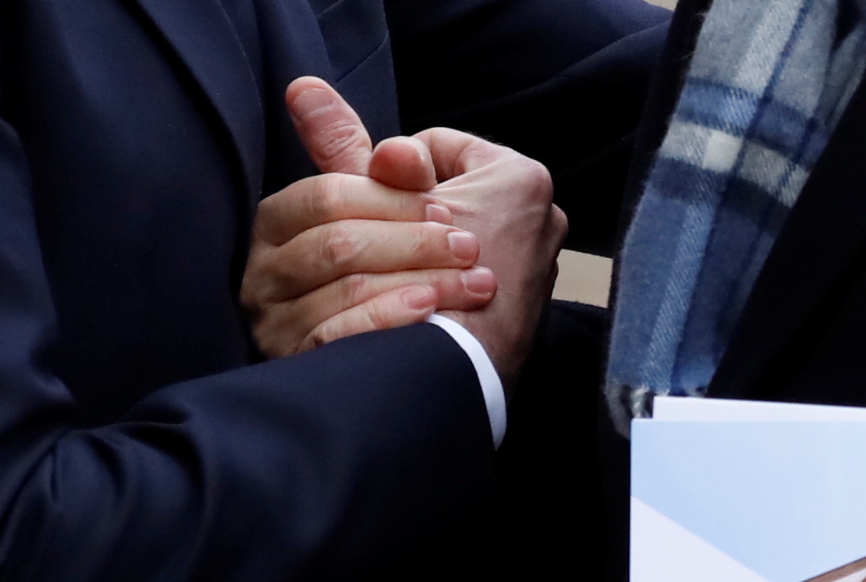 From bows to handshakes, how Macron let social distancing slip | Reuters