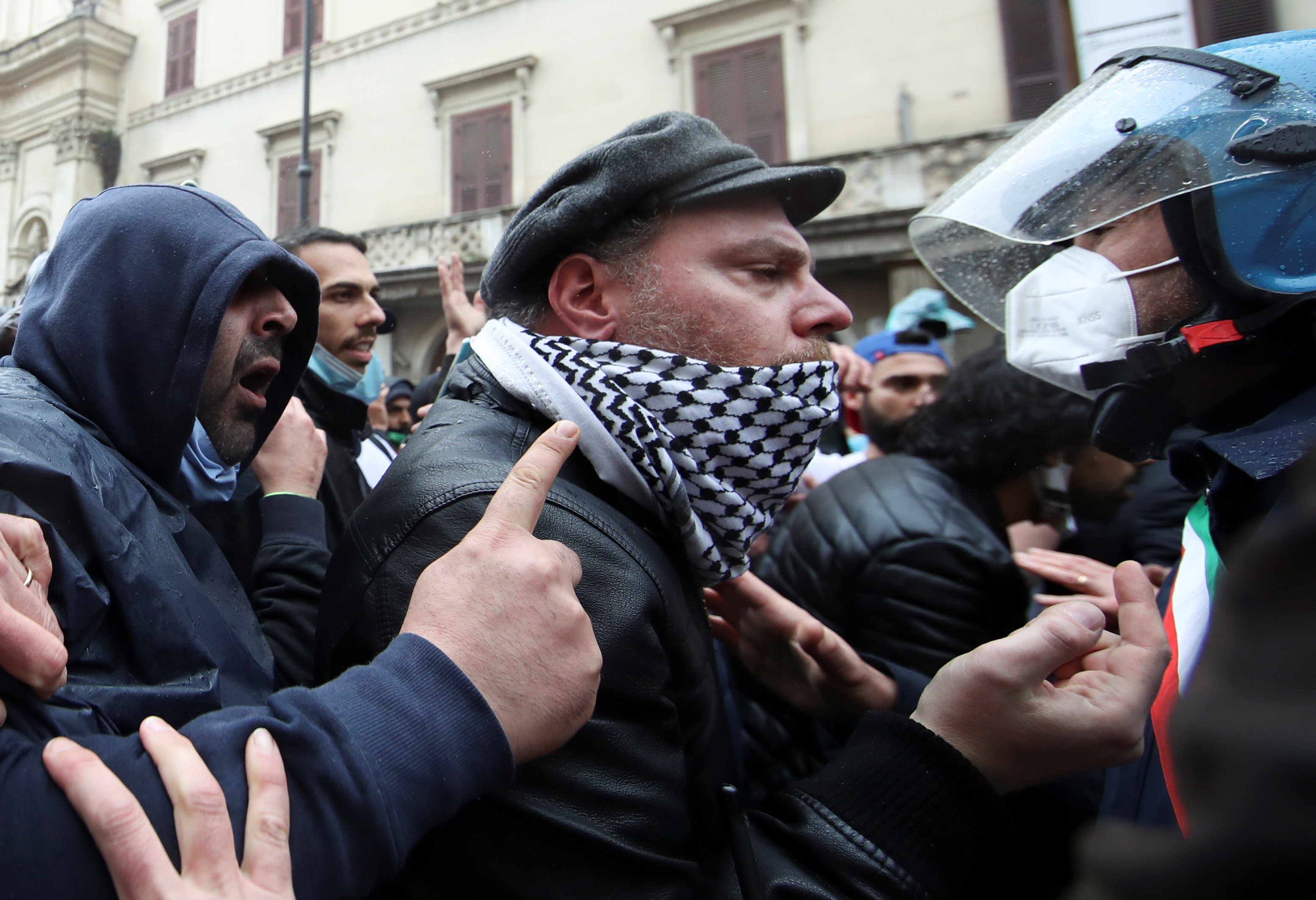 Protesters scuffle again with Italian police over COVID-19 curbs | Reuters