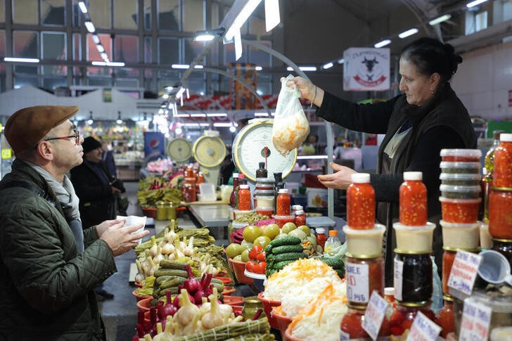 Putin grows war economy but incomes suffer 'lost decade' | Reuters