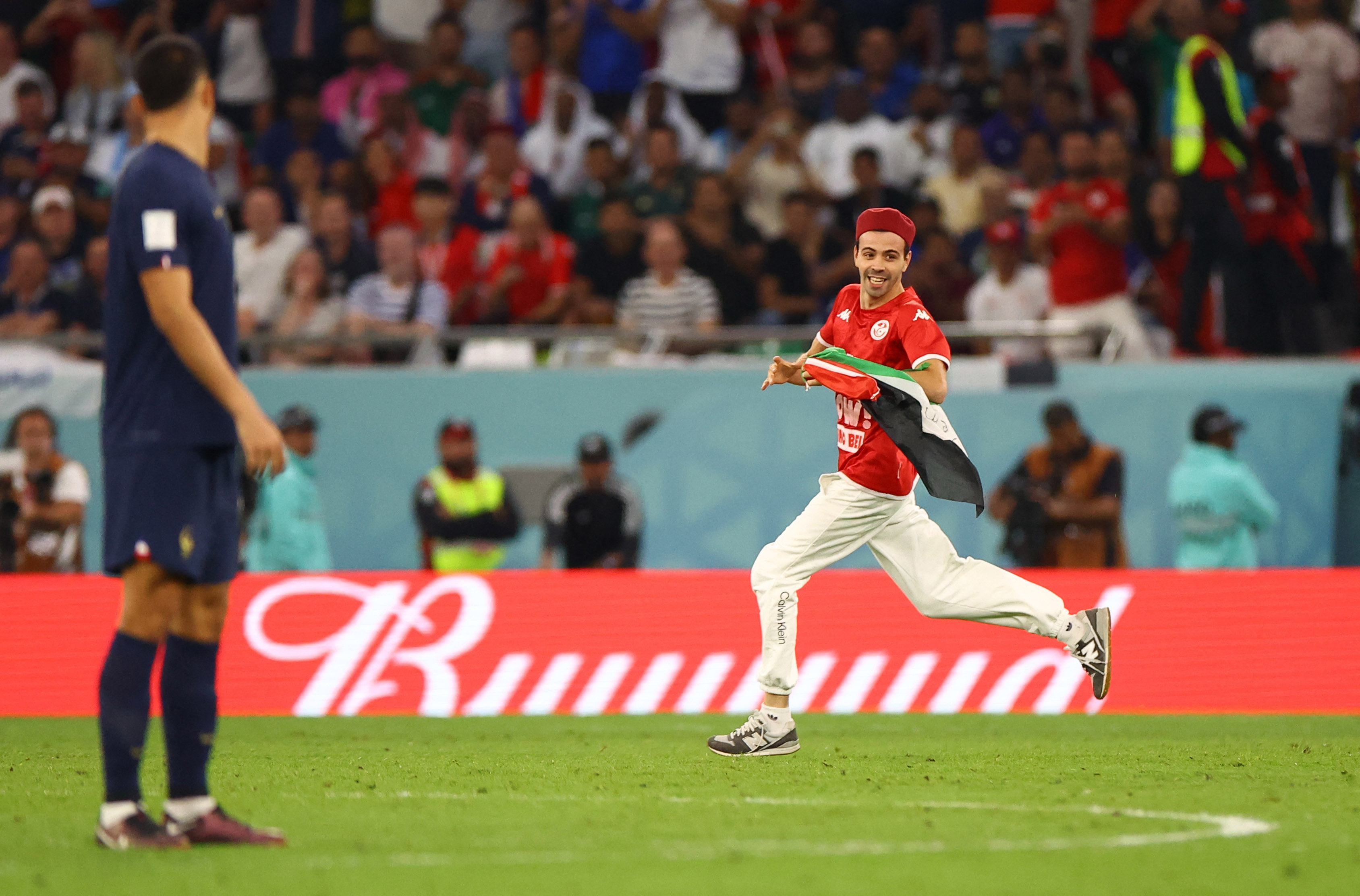 Supporter runs onto pitch during Tunisia v France game with Palestinian ...