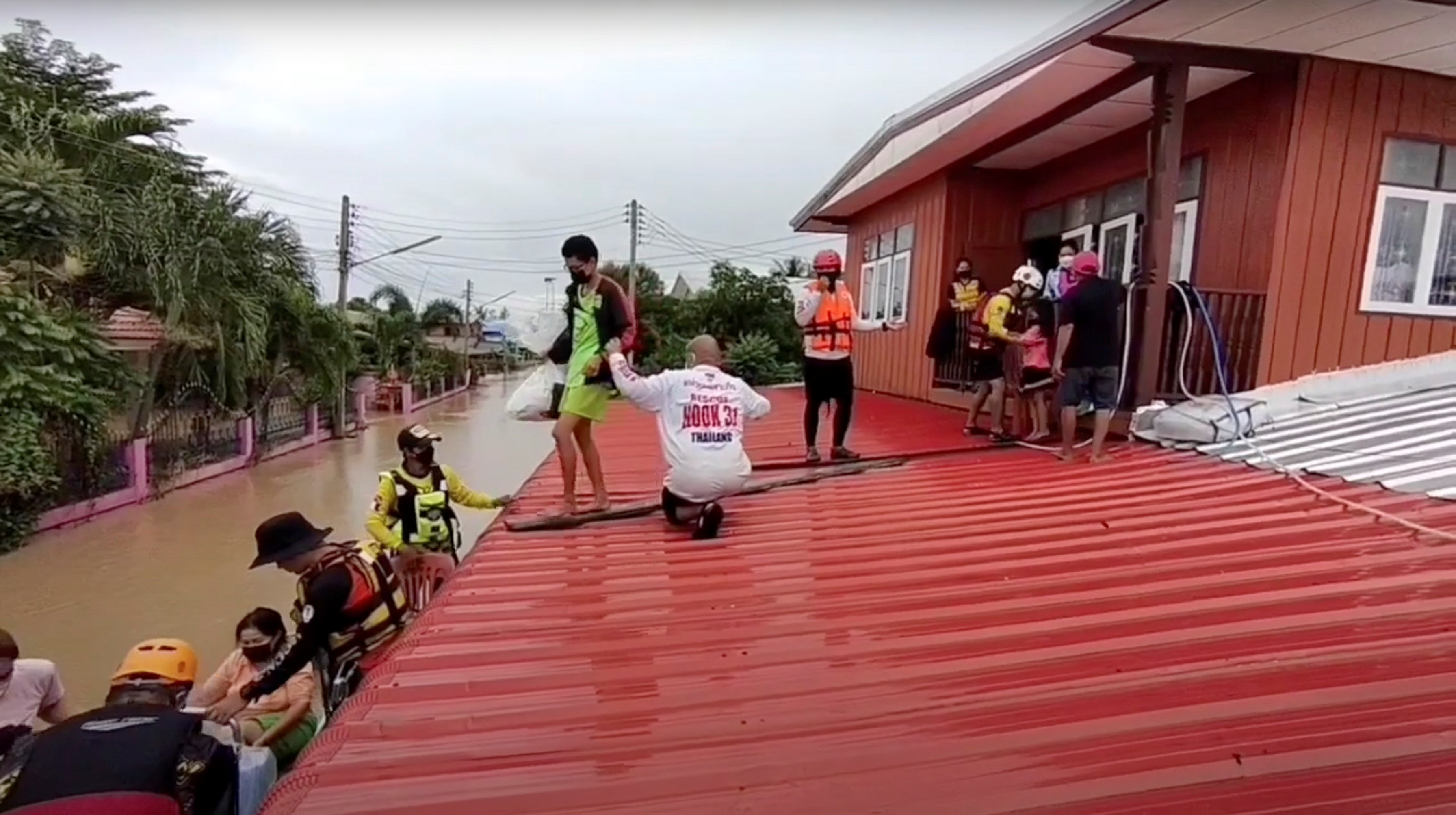Thai rescuers battle floodwaters to reach dozens stranded in homes ...