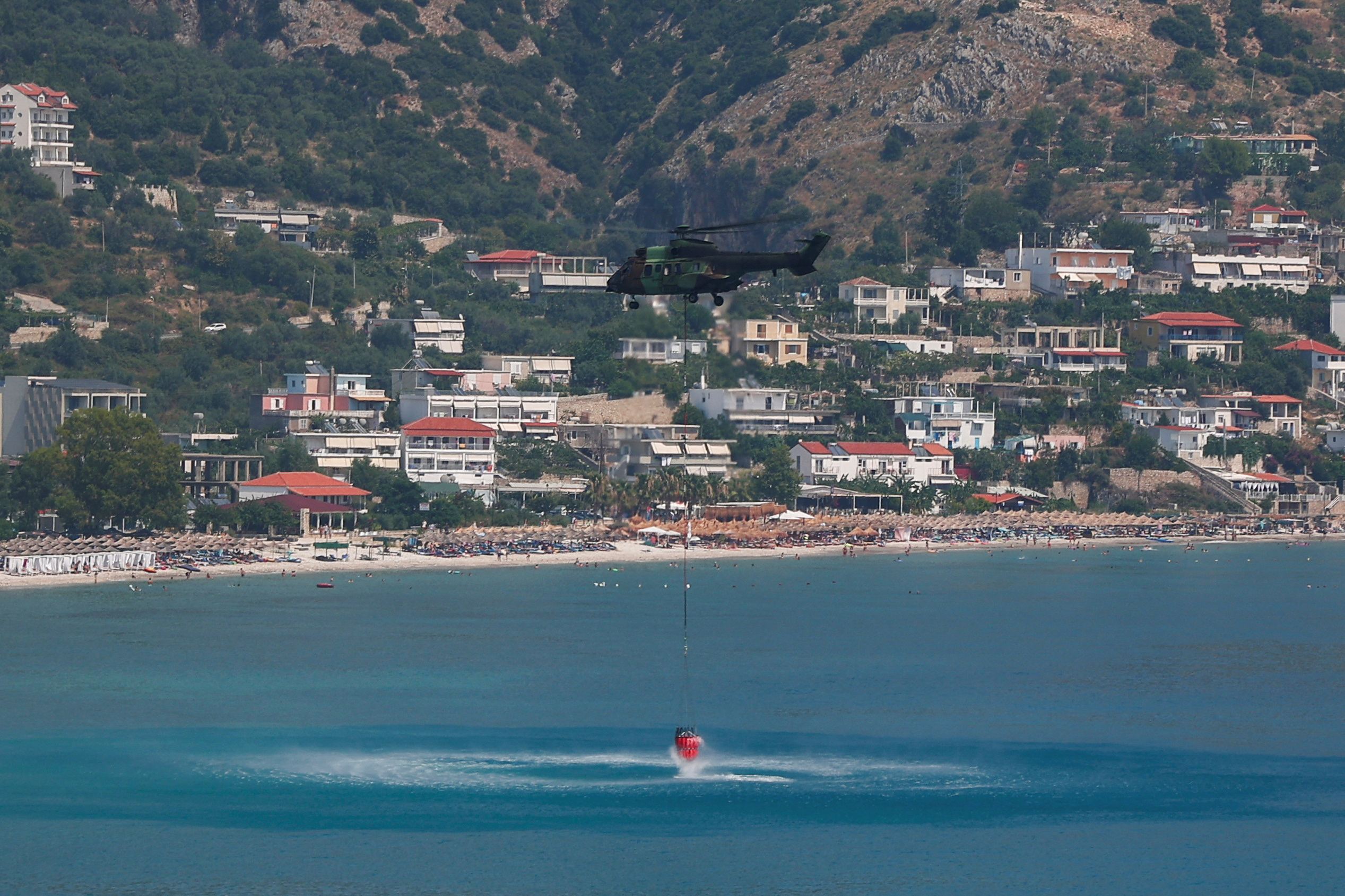 Albania battles coastal forest fires, arrests four | Reuters