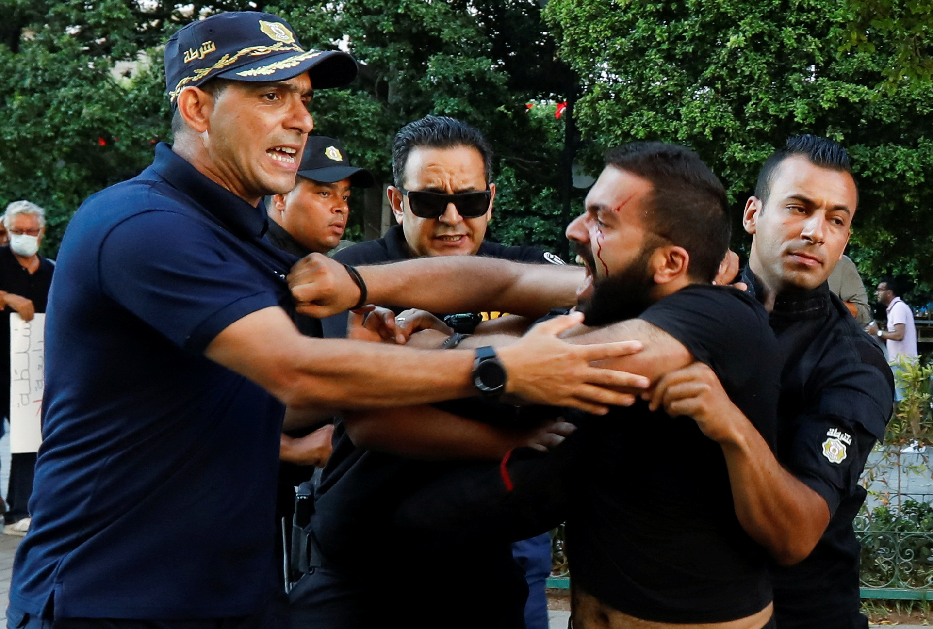 Tunisian police disperse protesters with pepper spray and sticks | Reuters