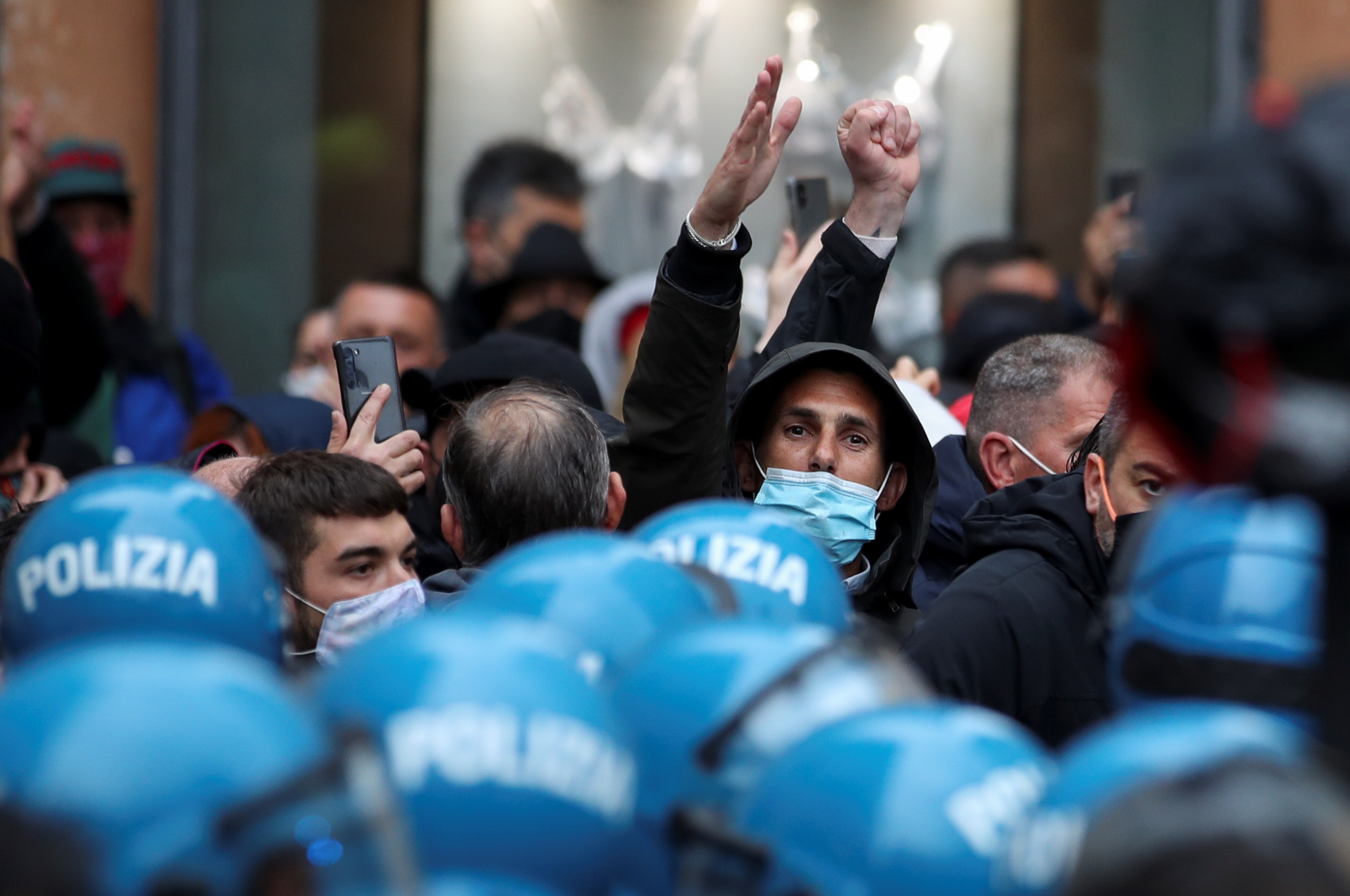 Protesters scuffle again with Italian police over COVID-19 curbs | Reuters