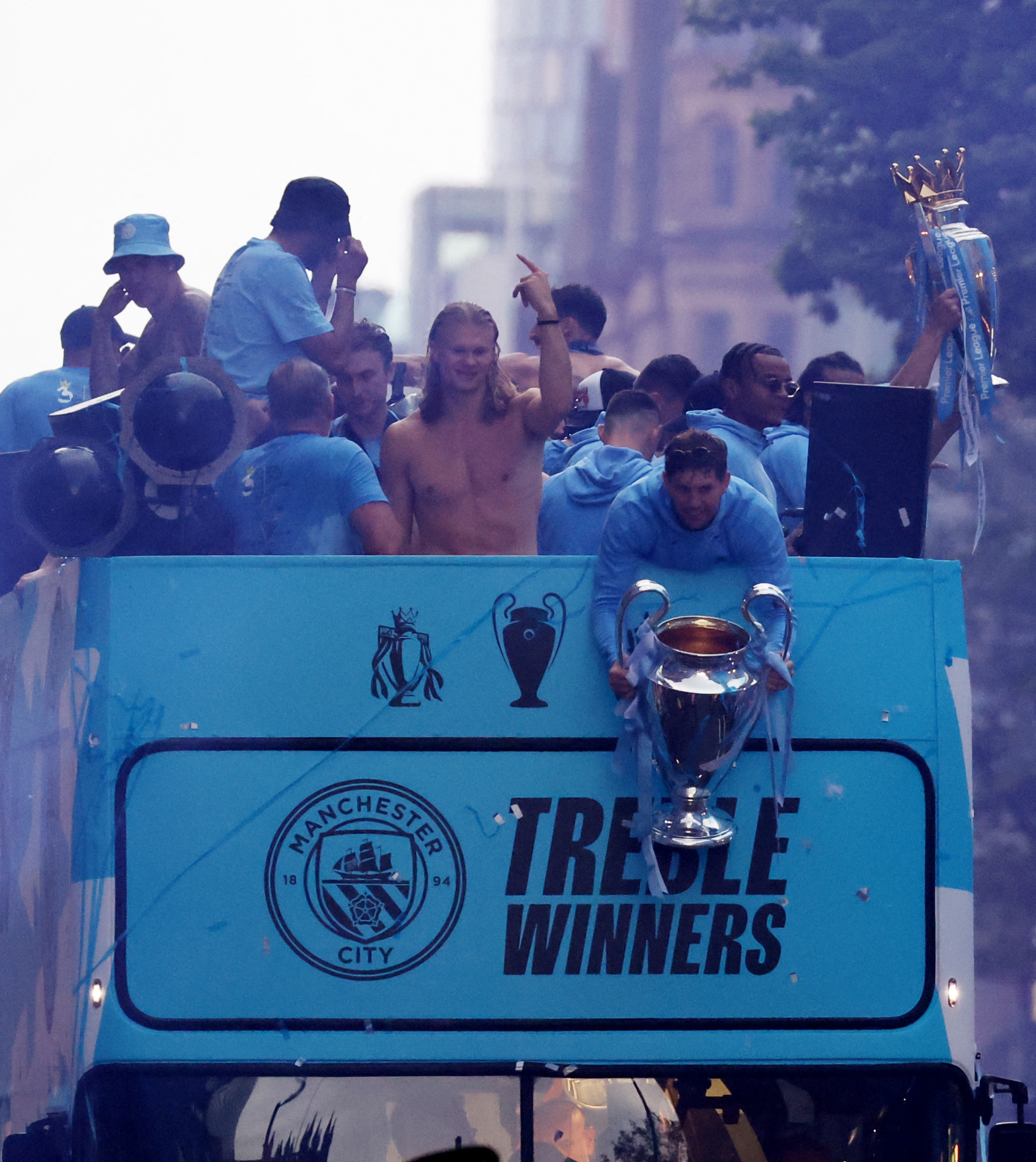 Manchester City dance in the rain to celebrate treble | Reuters