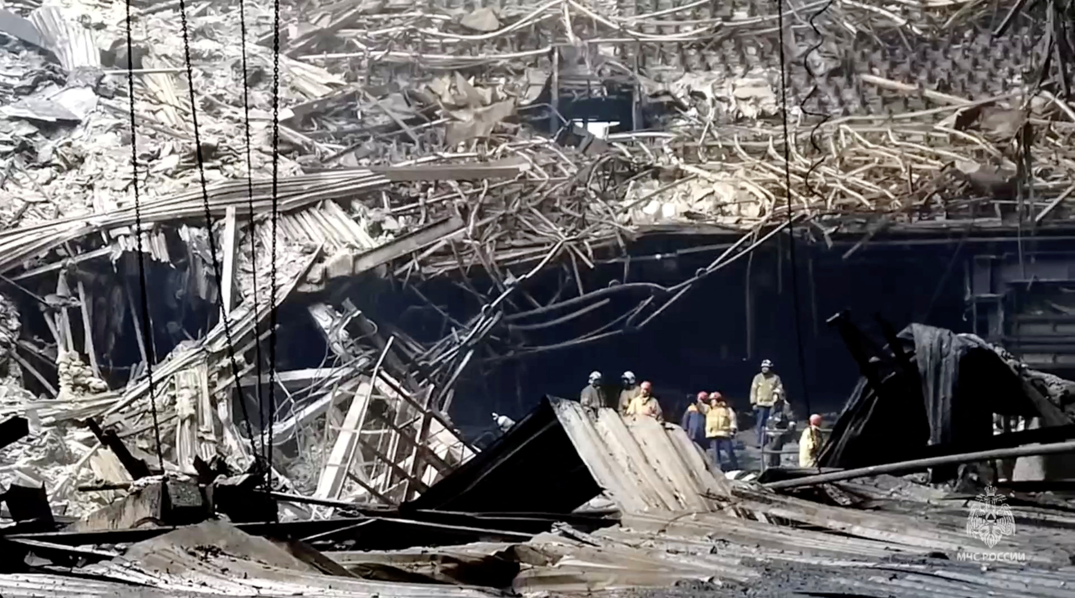Russians lower flags in mourning, suspects charged in deadly concert ...