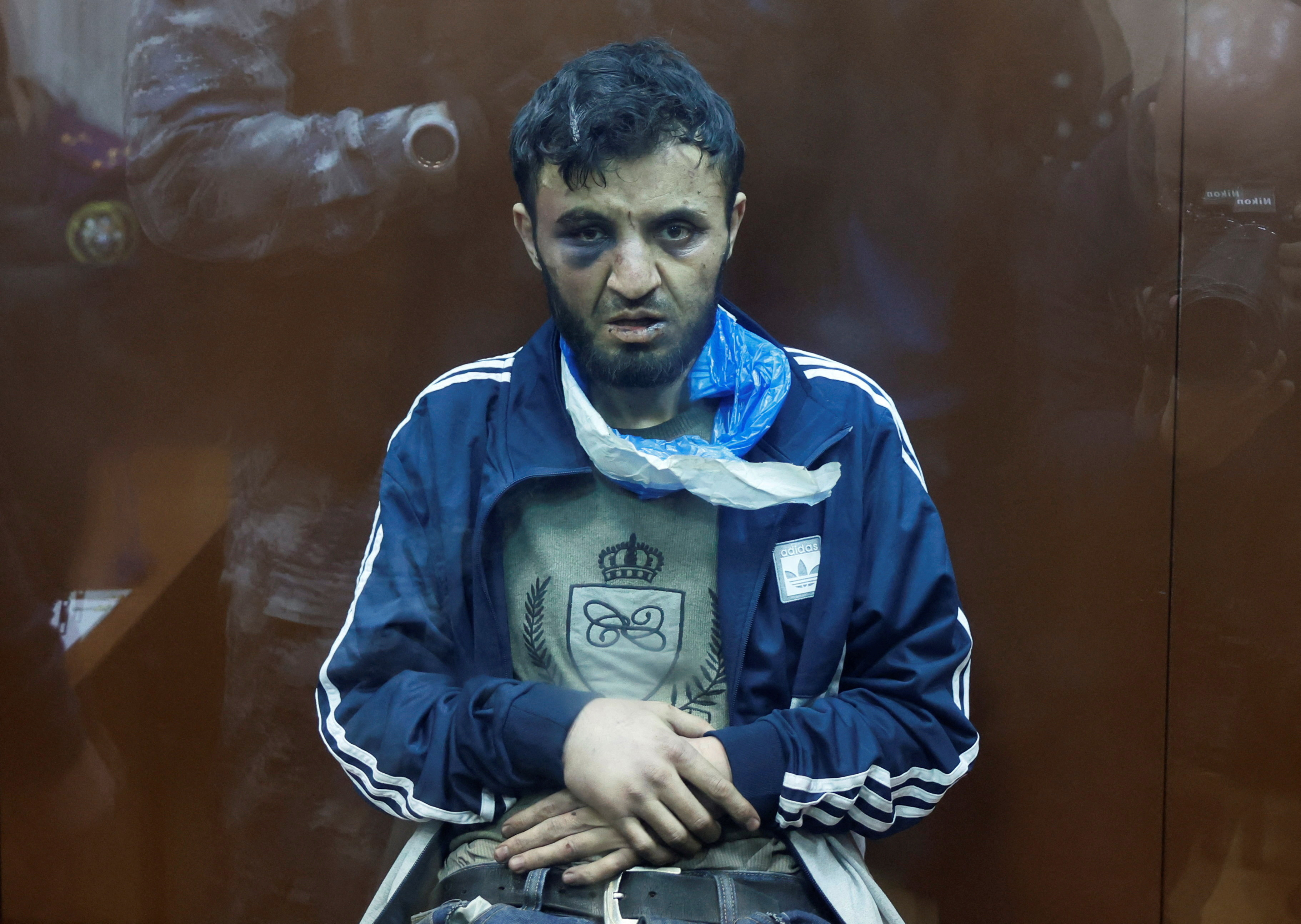 Russians lower flags in mourning, suspects charged in deadly concert ...