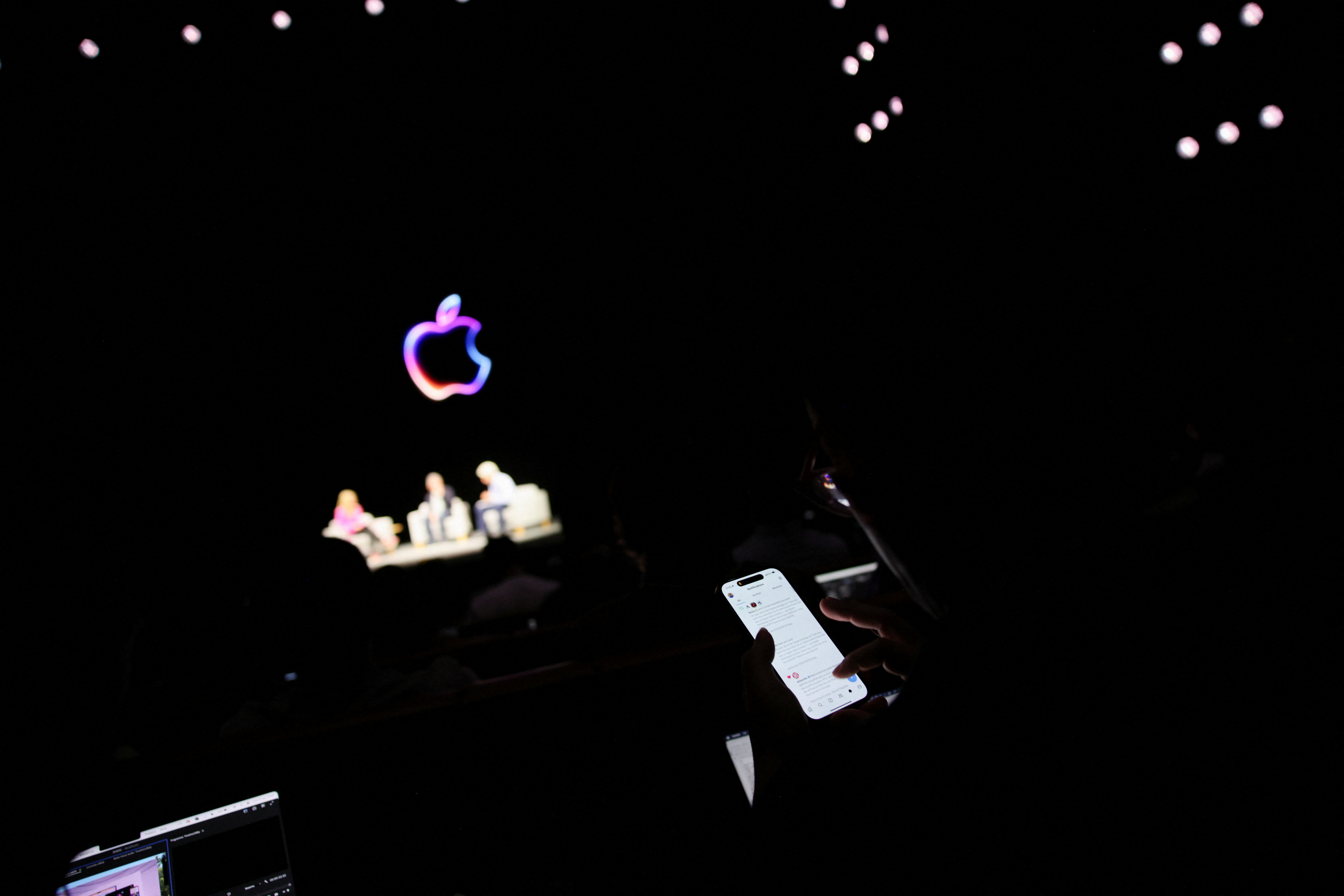 Apple hits record as AI features promise boost in iPhone sales | Reuters