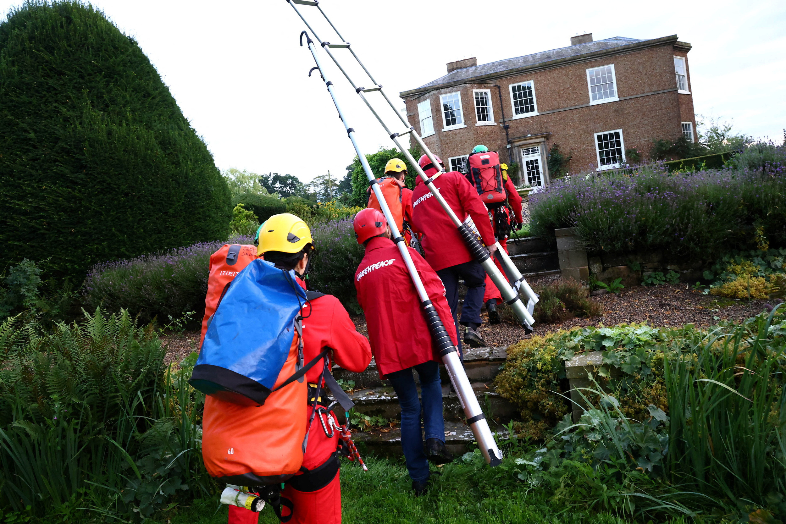 Greenpeace oil protesters cover Rishi Sunak's home in black fabric ...