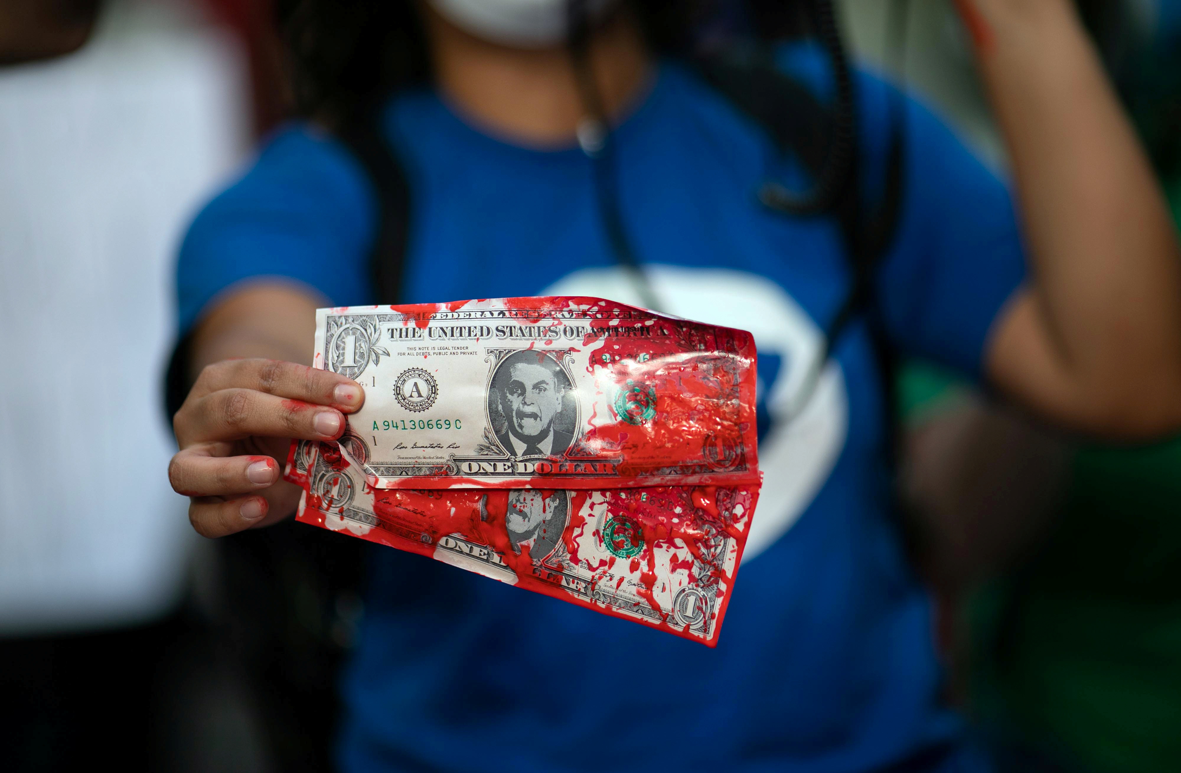 Brazilians demonstrate against Bolsonaro, slow vaccine rollout | Reuters