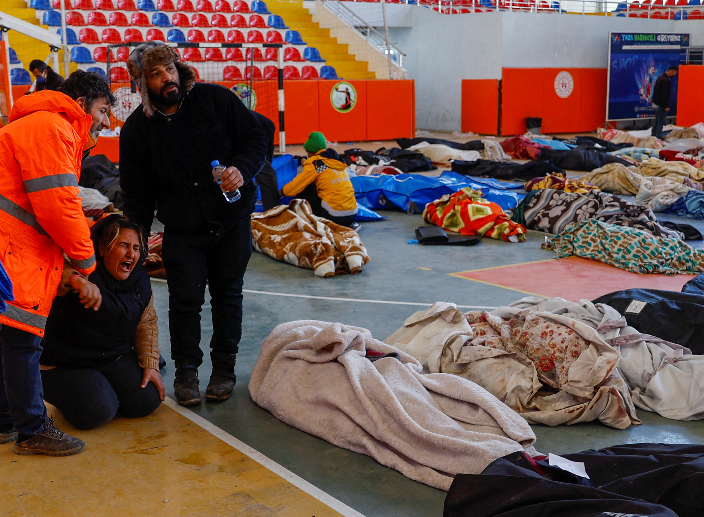 Amid rows of bodies, Turks check for relatives one by one after ...