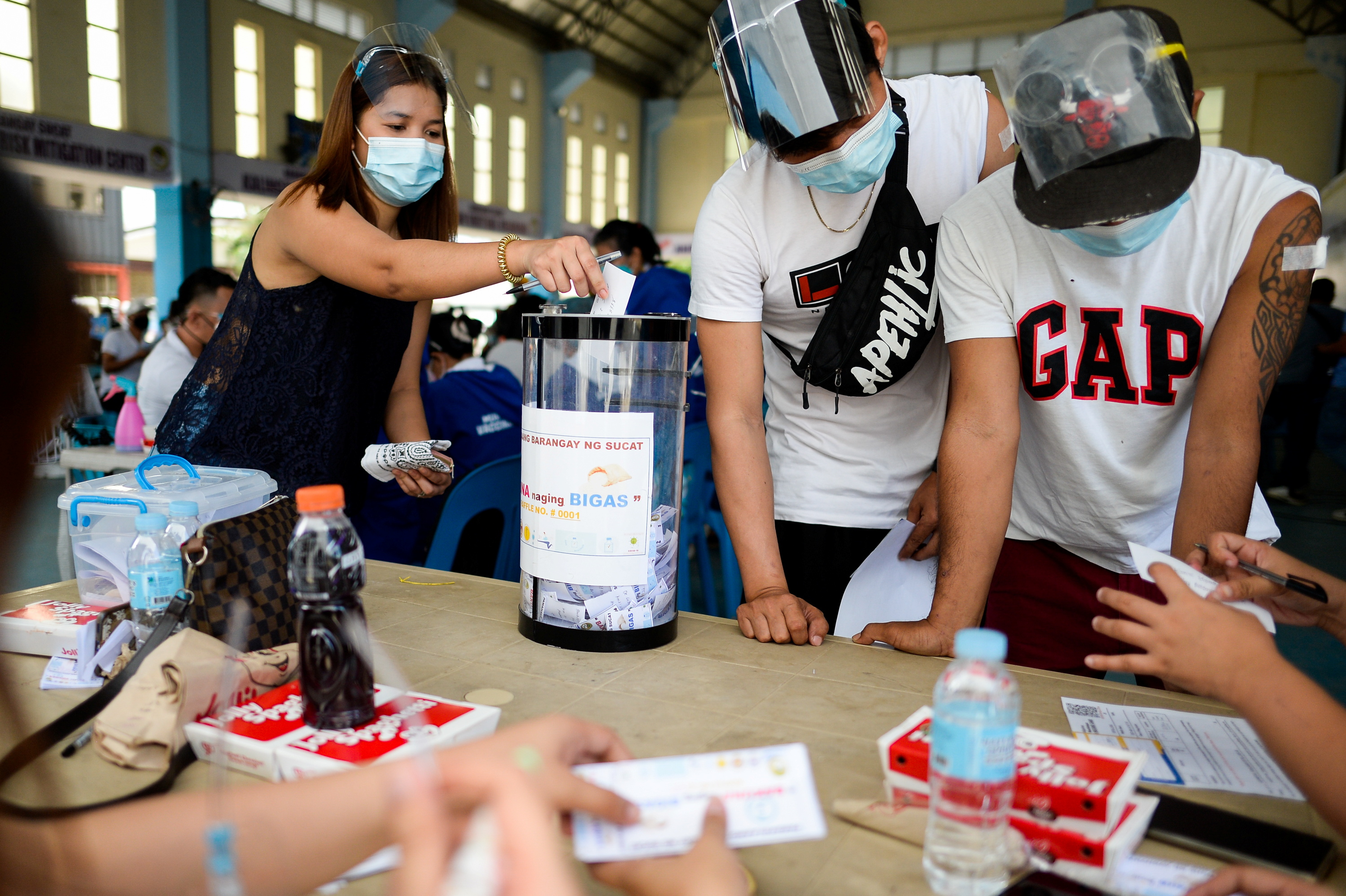 Philippines community raffles off bags of rice to boost vaccine drive ...