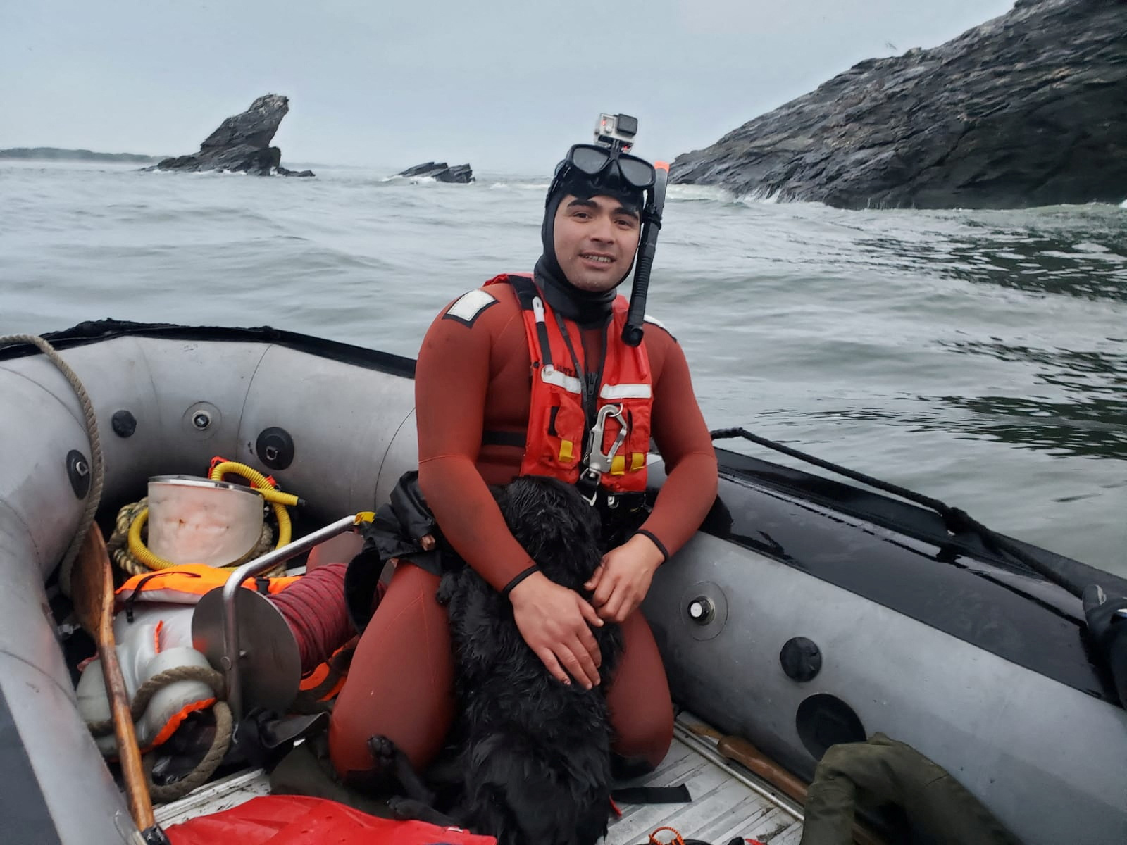 Rescuers save 'mermaid' dog trapped for days on Chilean river | Reuters