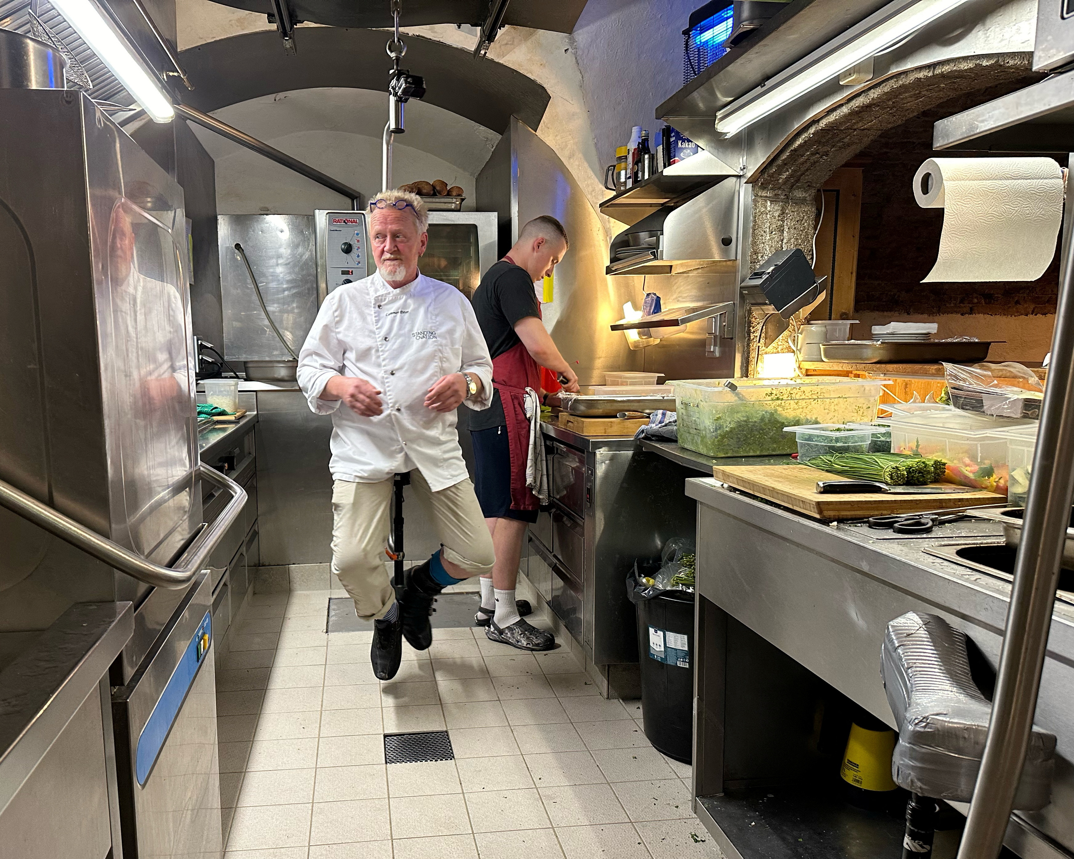 Austrian chef defies injury with floating kitchen seat | Reuters