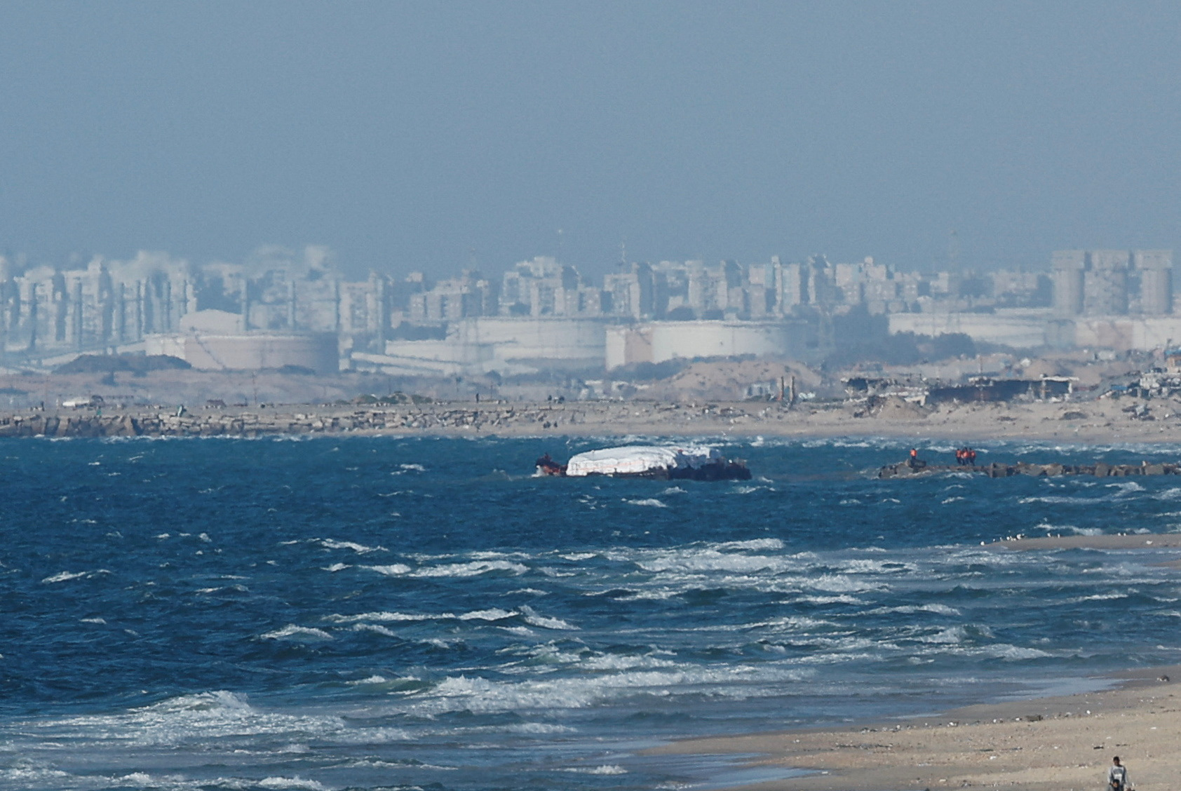Aid supply ship from Cyprus reaches Gaza coast but weather slows ...