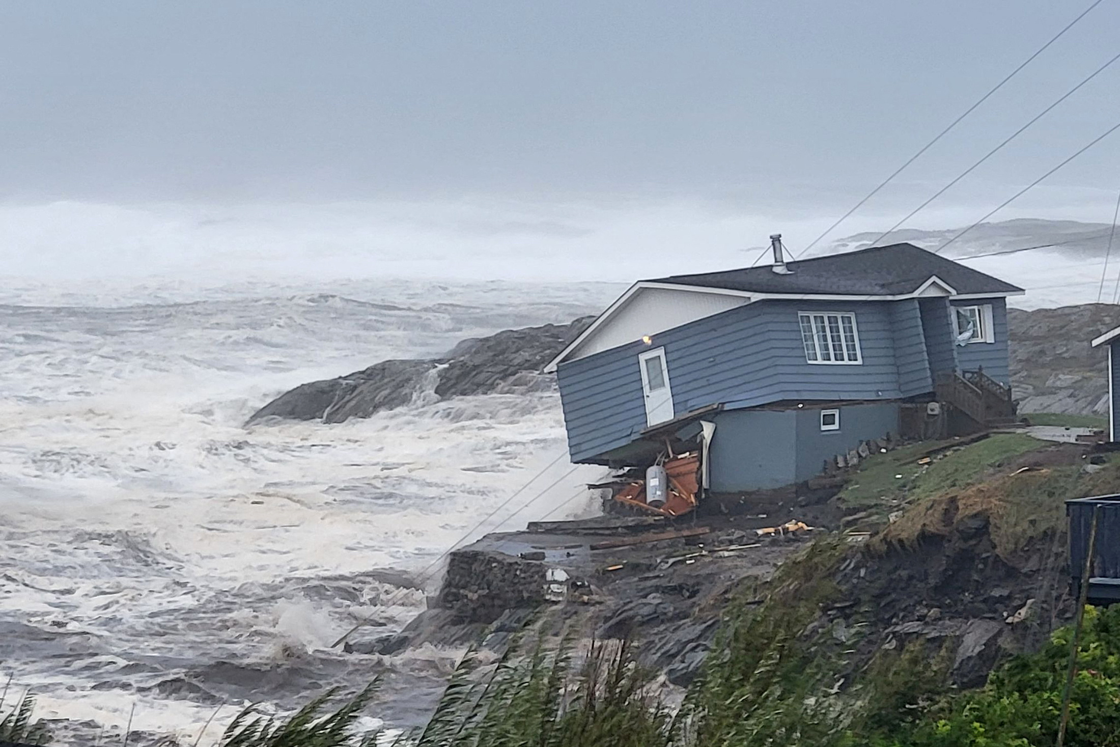 Canadians clean up after Fiona sweeps homes out to sea; one dead | Reuters