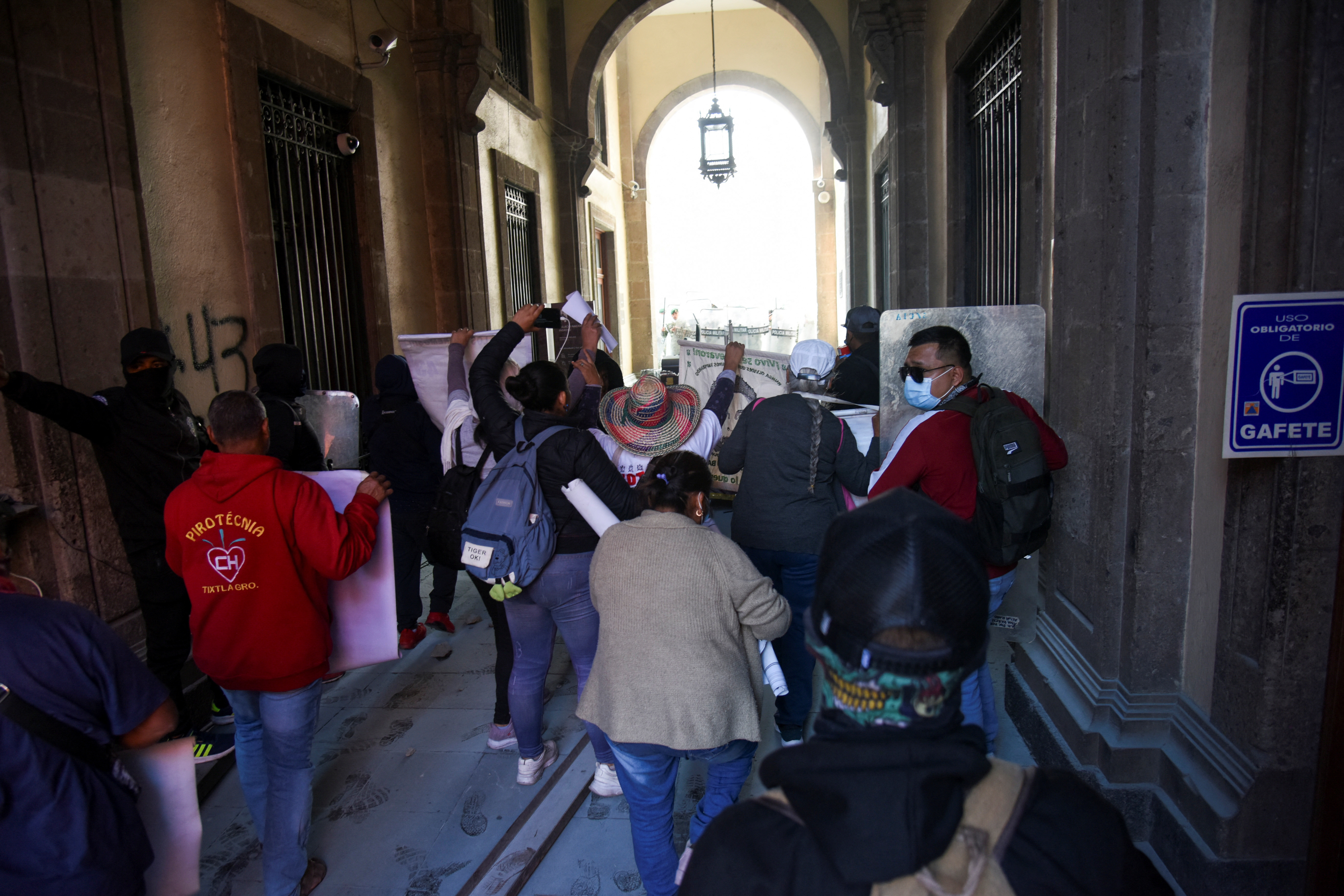 Protesters knock down door of Mexico's presidential palace | Reuters