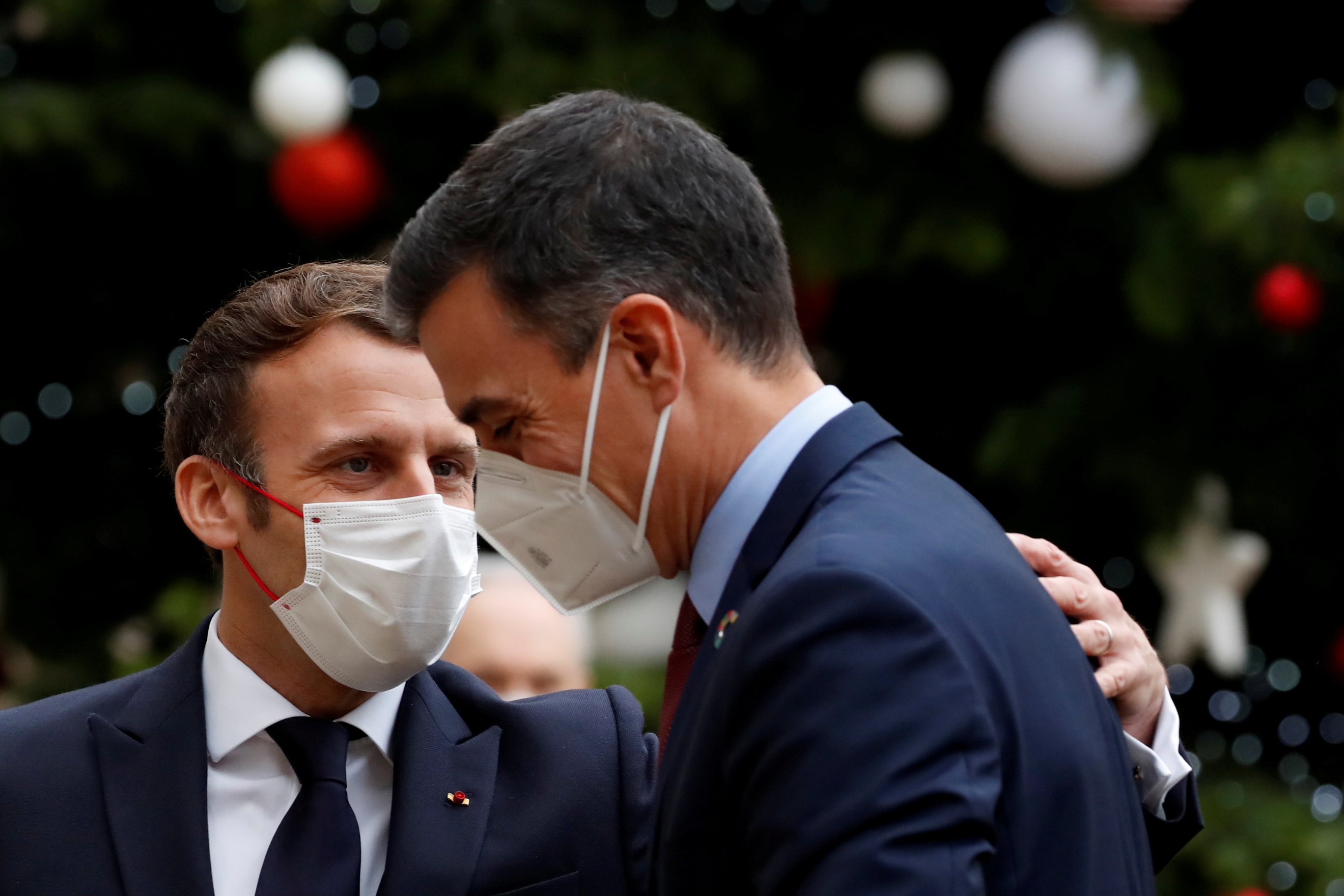 From bows to handshakes, how Macron let social distancing slip | Reuters