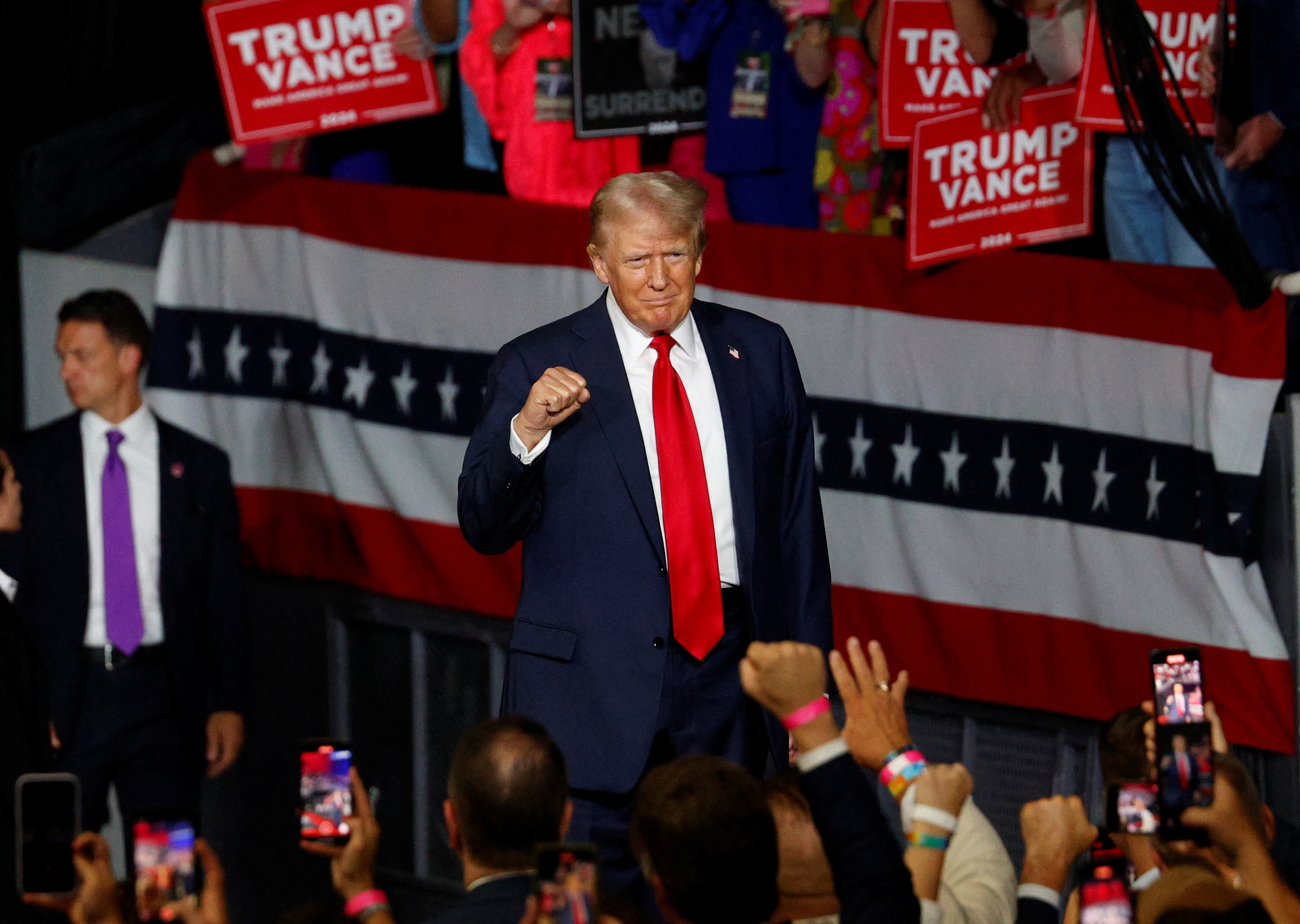 Biden says he bowed out to unite nation, as Trump attacks Harris | Reuters