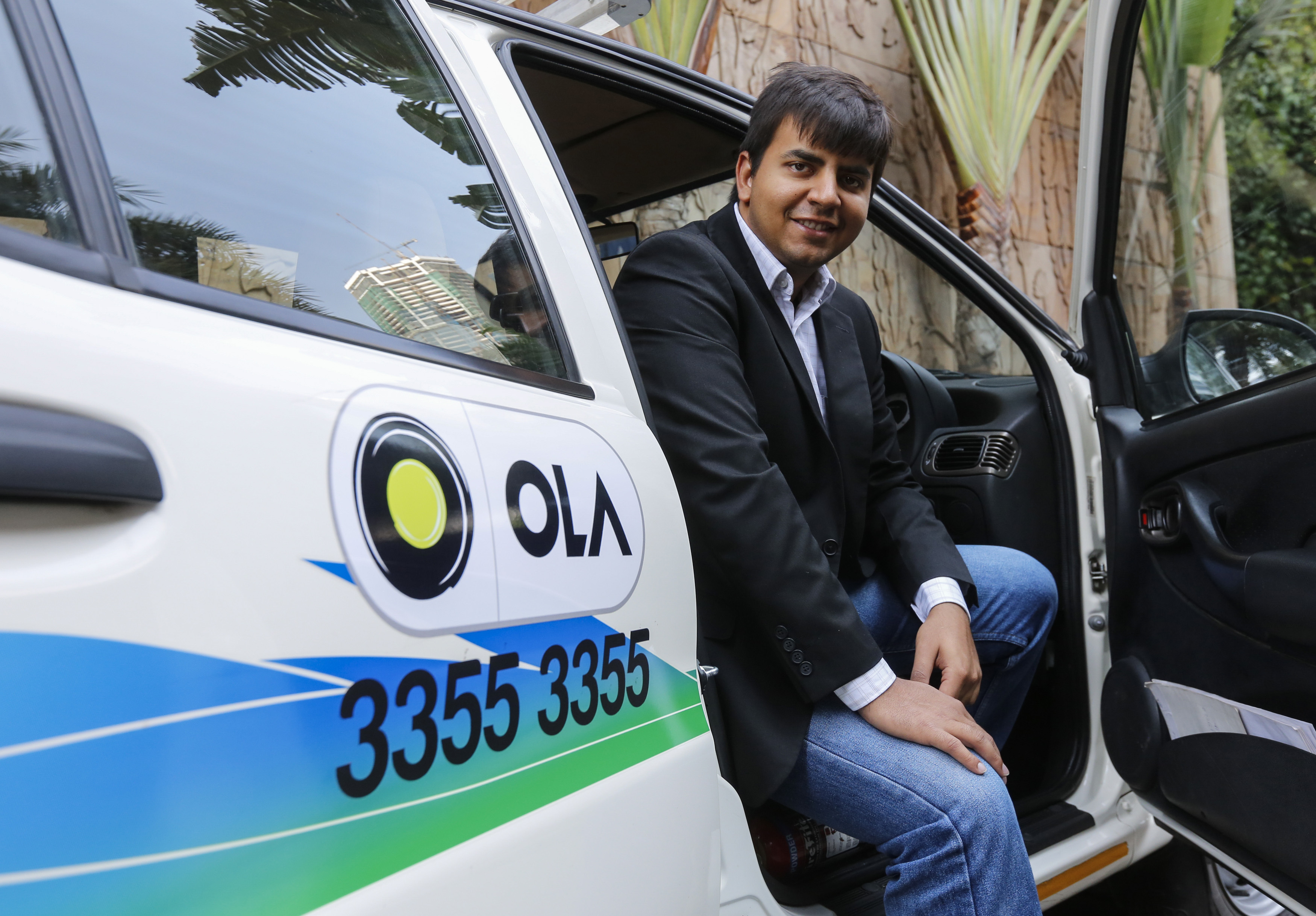 SoftBank-backed Ola Electric suspends India car project to focus on ...